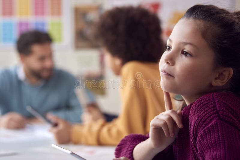 Concentrating Female Student Sitting at Desk in Elementary School ...