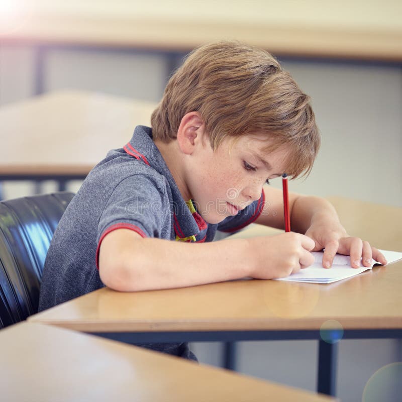 Concentrating on His Classwork. a Little Boy Doing His Work in Class ...