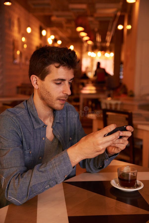 Concentrating Millenial Texting in a Restaurant Stock Photo - Image of ...
