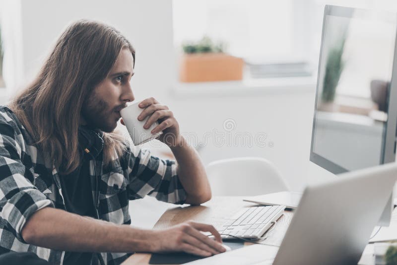 Concentrating at work. stock image. Image of drinking - 81455651