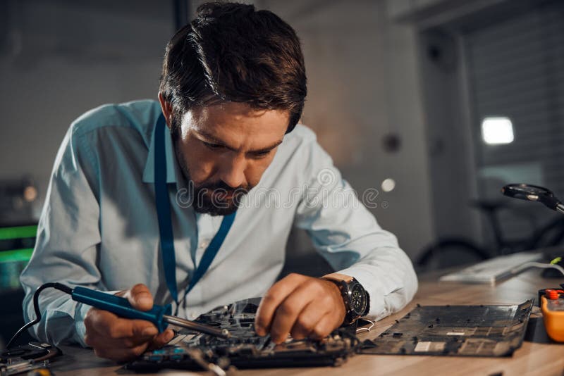 Concentration Man, it or Soldering Motherboard in Engineering Workshop ...