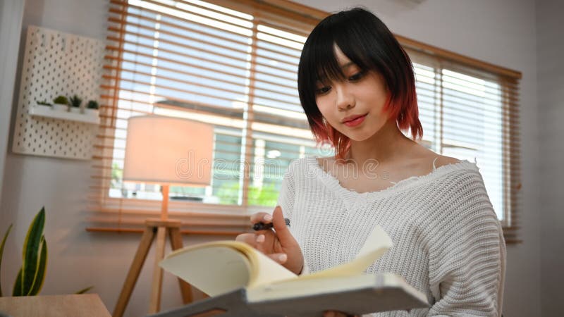 Concentred Asian Female Freelancer Reading Literature or Checking Her ...