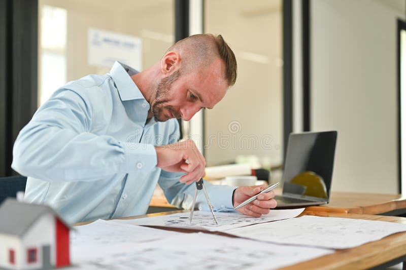 Concentred Caucasian Architect Man Working with Blueprint, Sketching a ...