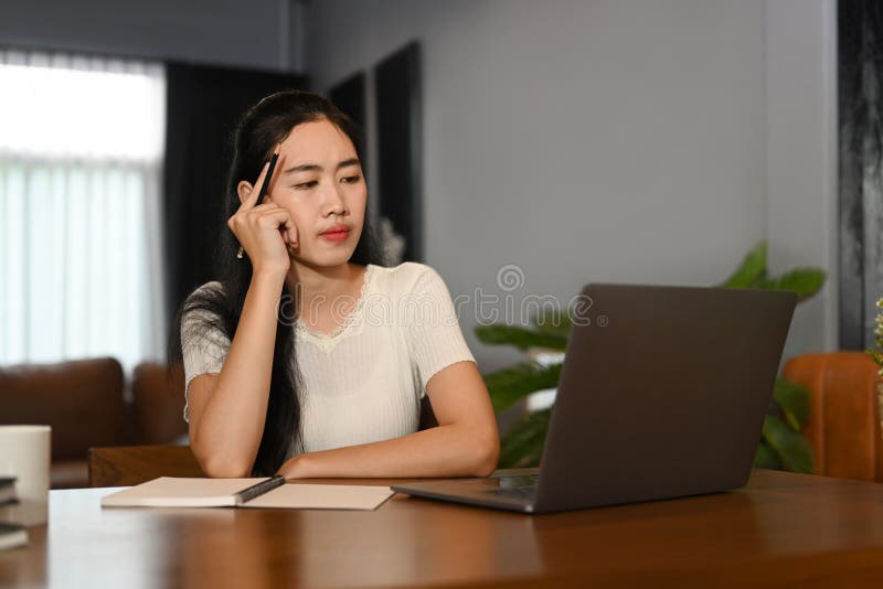 Concentred Young Woman Looking at Computer Tablet while Studying Online ...
