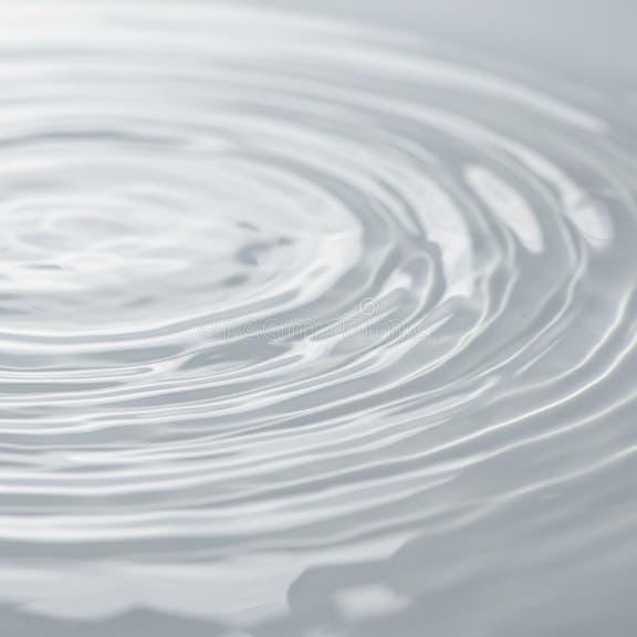 Concentric Water Ripples Spread Outward on a Smooth, Reflective Water ...