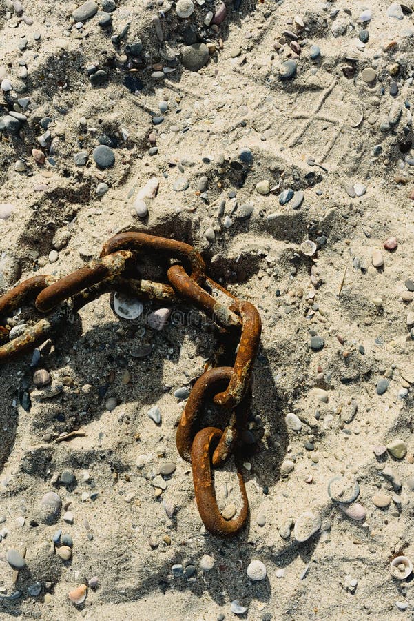 Concept of Abandonment, Old Rusty and Broken Chains Thrown in the Sand ...