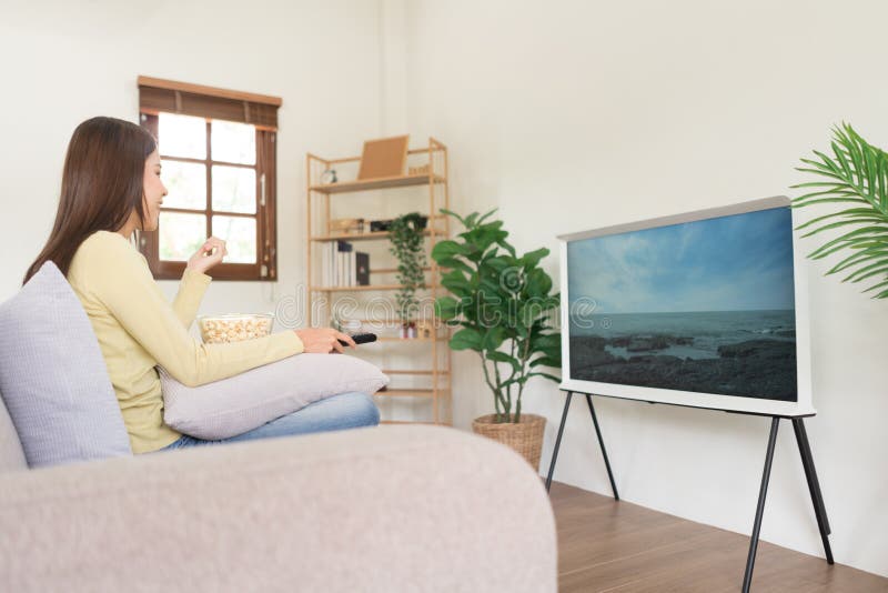 Concept of Activity in Home, Young Woman Holds Remote Control To ...