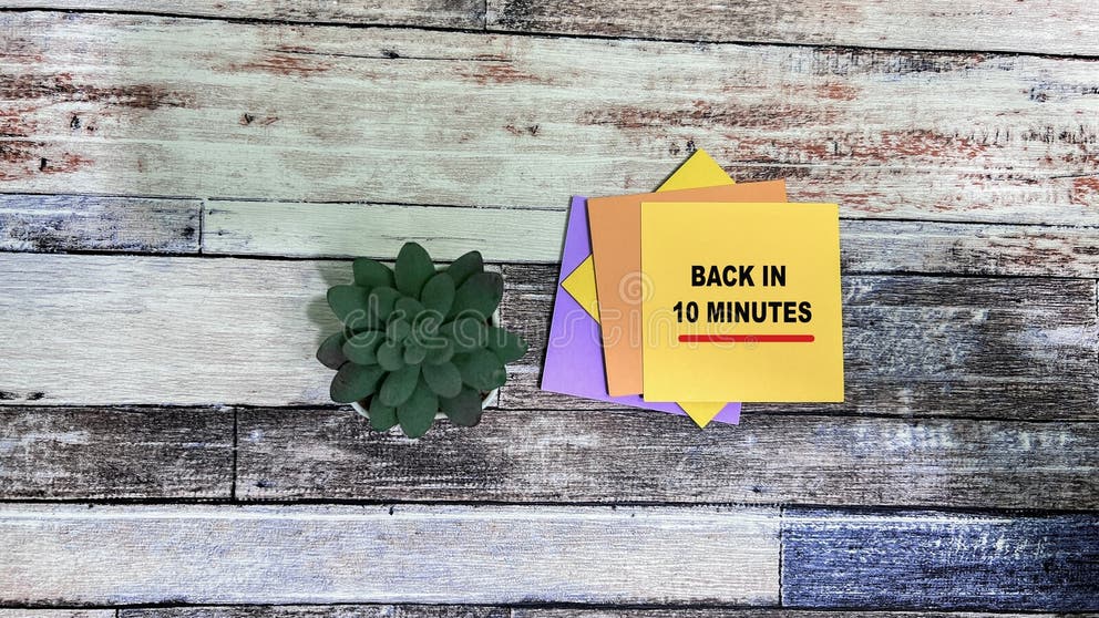 Concept of Back in 10 Minutes Write on Sticky Notes Isolated on Wooden ...