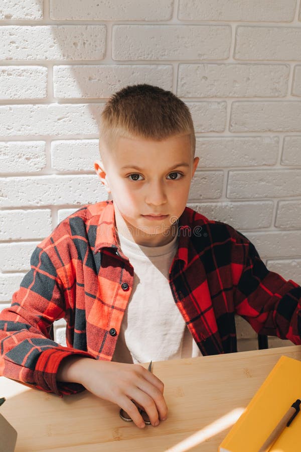 Concept Back To the School. a Boy in the Process of Studying Sits at a ...