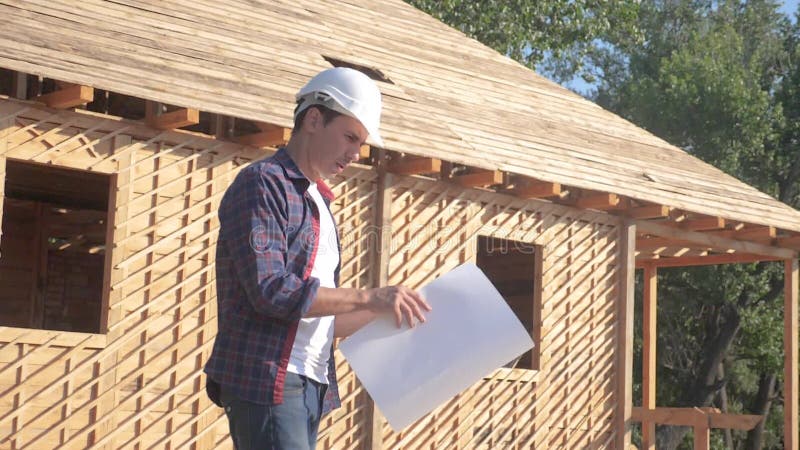 Concept Building Constructing Architect Slow Motion Video. Man Builder in a Helmet Stands at ...