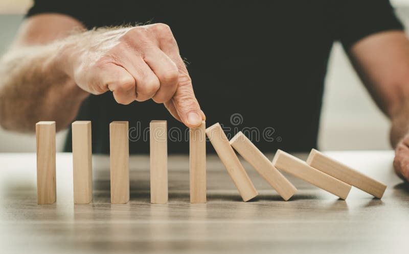 Concept of Business Control by Stopping Domino Effect Stock Photo ...