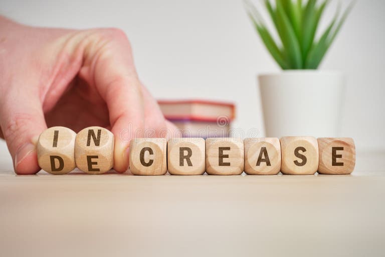 The Concept of Choice Increase and Decrease on Wooden Cubes is Turned Over by Hand Stock Image ...