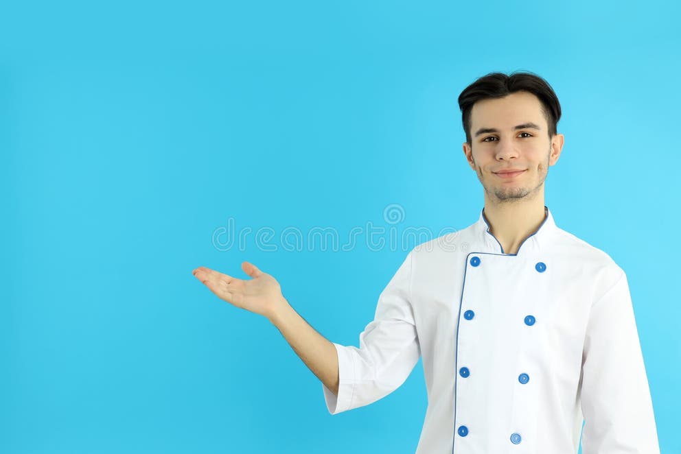 Concept of Cooking, Young Man Chef on Blue Background Stock Photo ...