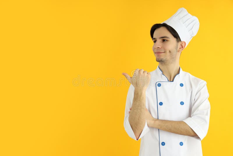 Concept of Cooking, Young Man Chef on Yellow Background Stock Image ...