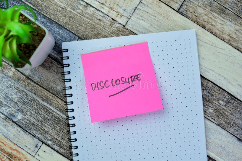 Concept Of Disclosure Write On Sticky Notes Isolated On Wooden Table