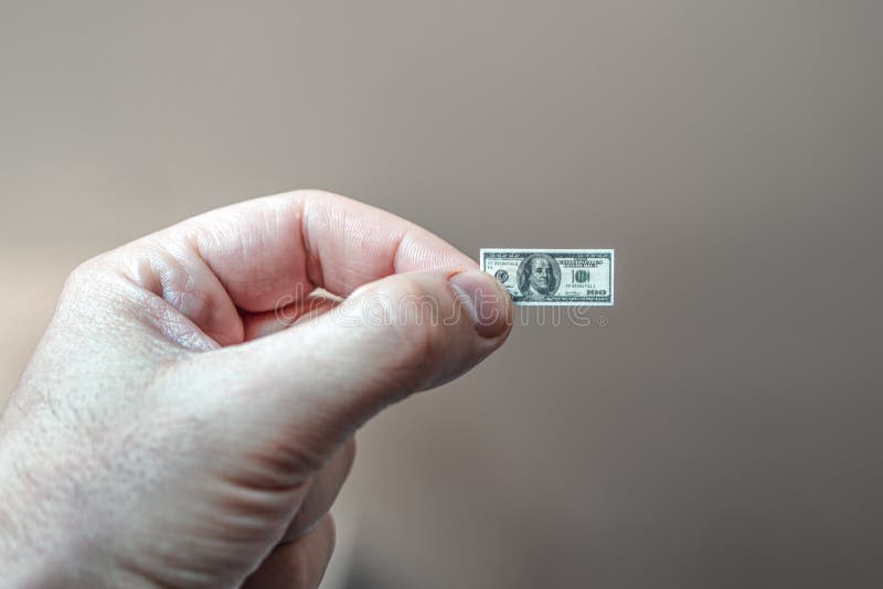 Concept of Dollar Inflation. Cash on Hand. Hand Holding Miniature ...