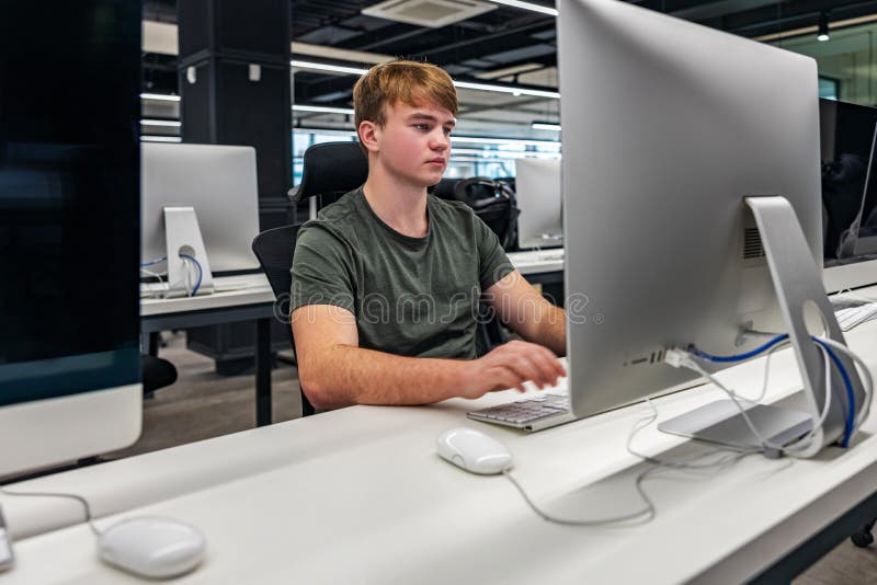 The Concept of Education, a Young Man Sits at a Computer, Teaches ...