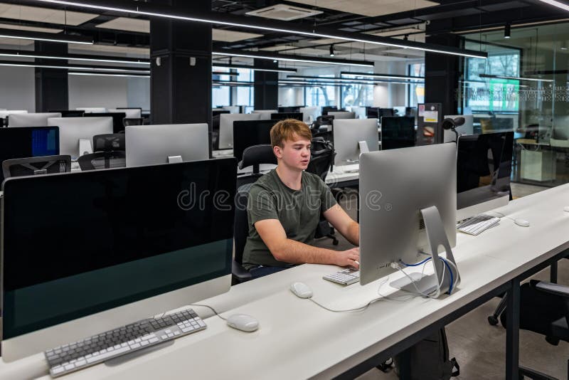 The Concept of Education, a Young Man Sits at a Computer, Teaches ...