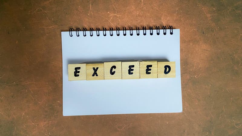 Concept of Exceed Writing on Wooden Cube Isolated on Work Desk. Stock ...