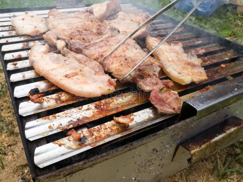 The Concept of Fast and Delicious Food. Frying Meat on the Grill Stock ...