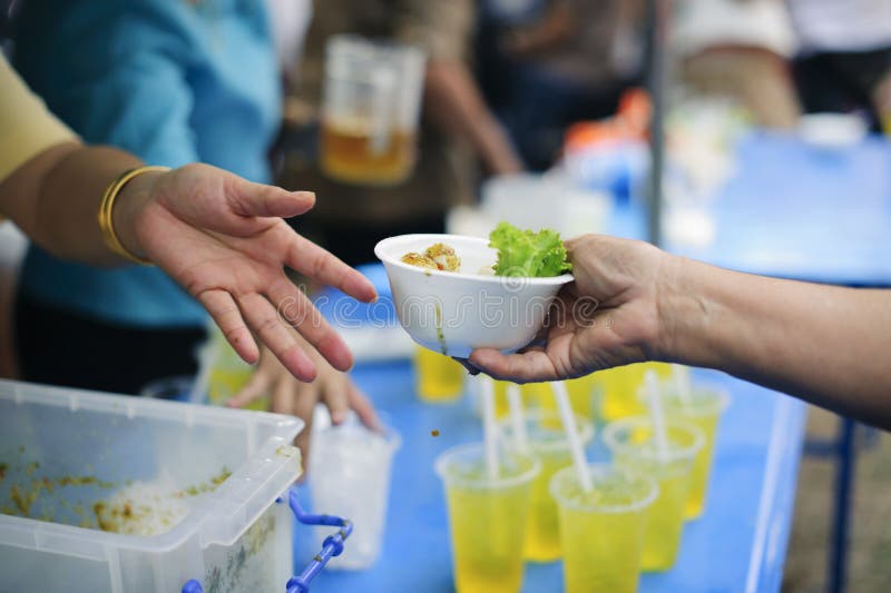 The Hands of the Poor Handed a Plate To Receive Food from Volunteers To ...