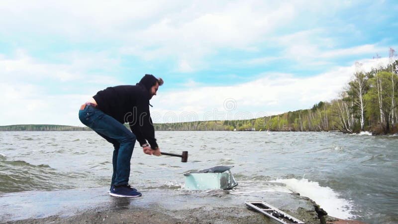 Man Breaks a Hammer System Unit Computer. Man with a Sledge Hammer and ...