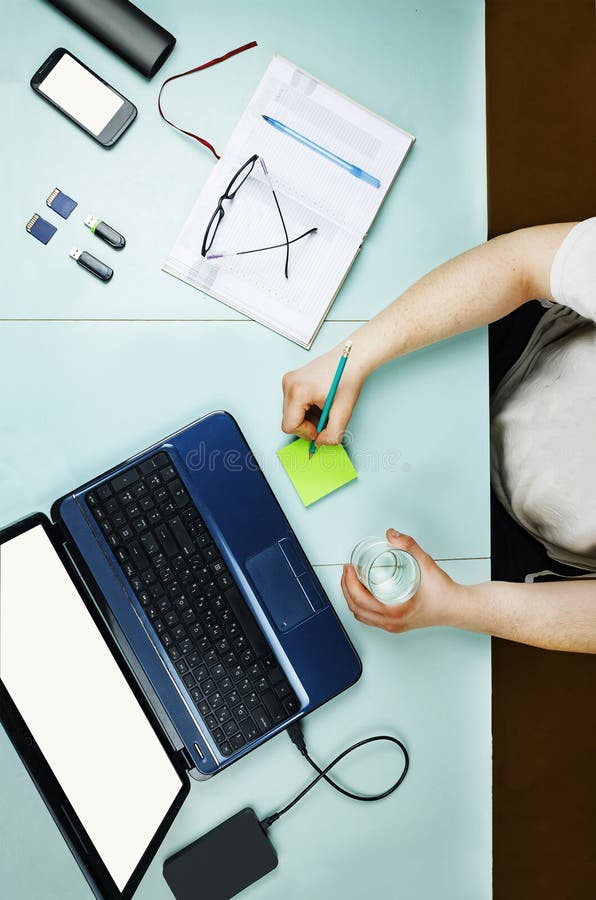Young Freelancer Working at Home at a Table Using a Laptop Stock Photo ...