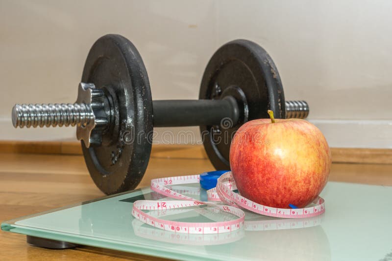 Concept - Getting in Shape, Measuring Tape, Apple, Scale and Dumbbell ...