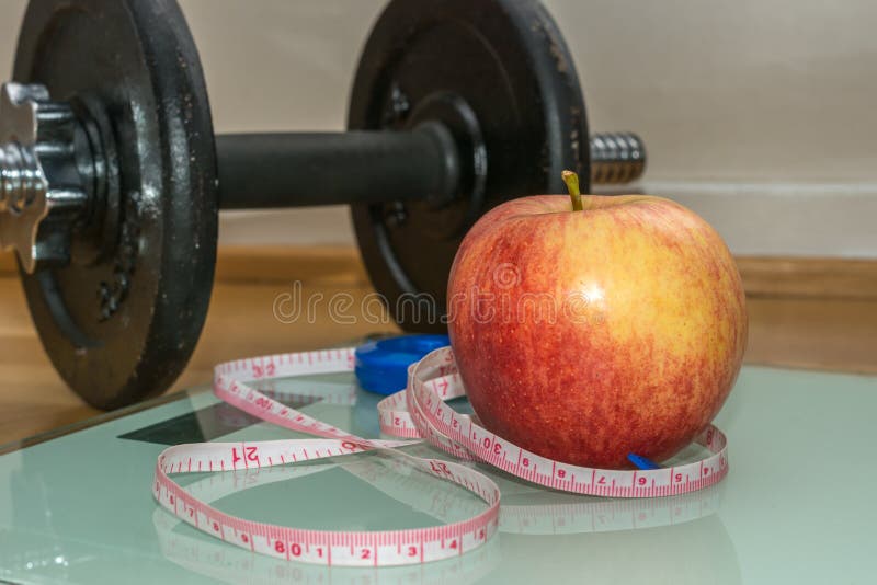 Concept - Getting in Shape, Measuring Tape, Apple, Scale and Dumbbell ...