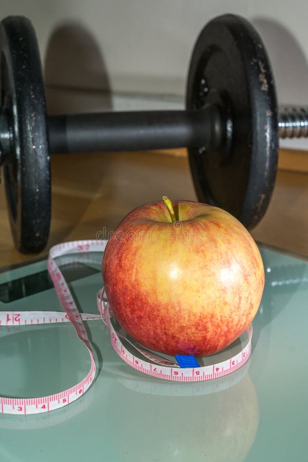 Concept - Getting in Shape, Measuring Tape, Apple, Scale and Dumbbell ...