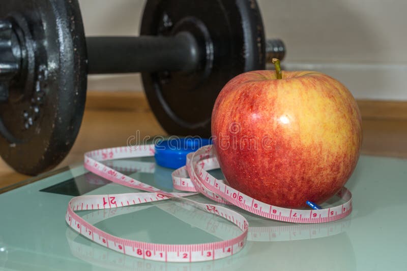 Concept - Getting in Shape, Measuring Tape, Apple, Scale and Dumbbell ...
