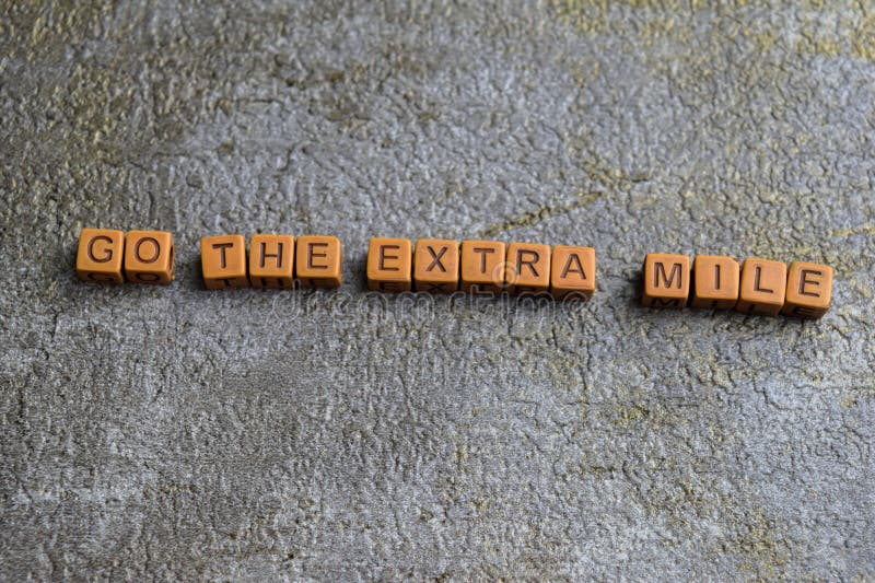 Concept of Go the Extra Mile Written on Wooden Blocks. Cross Processed ...