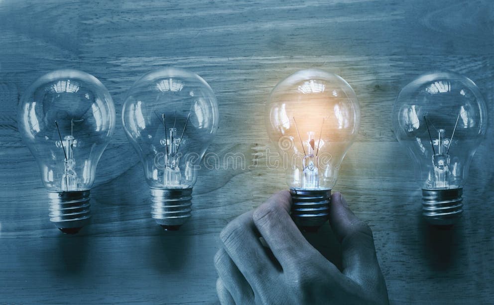 Concept Hand and Light Bulb Isolate on Wood Stock Image - Image of ...