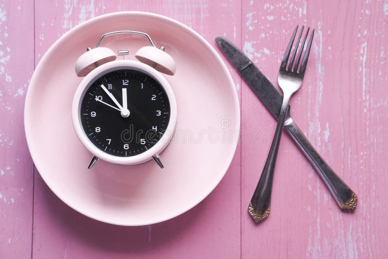 The Concept of Healthy Food, Alarm Clock on Plate Stock Photo - Image ...