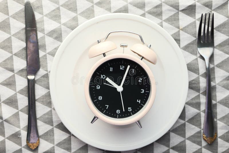 The Concept of Healthy Food, Alarm Clock on Plate Stock Photo - Image ...