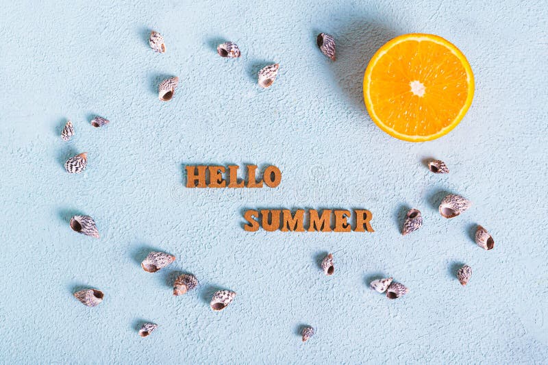 Concept Hello Summer Text, Half an Orange and Seashells on a Blue ...