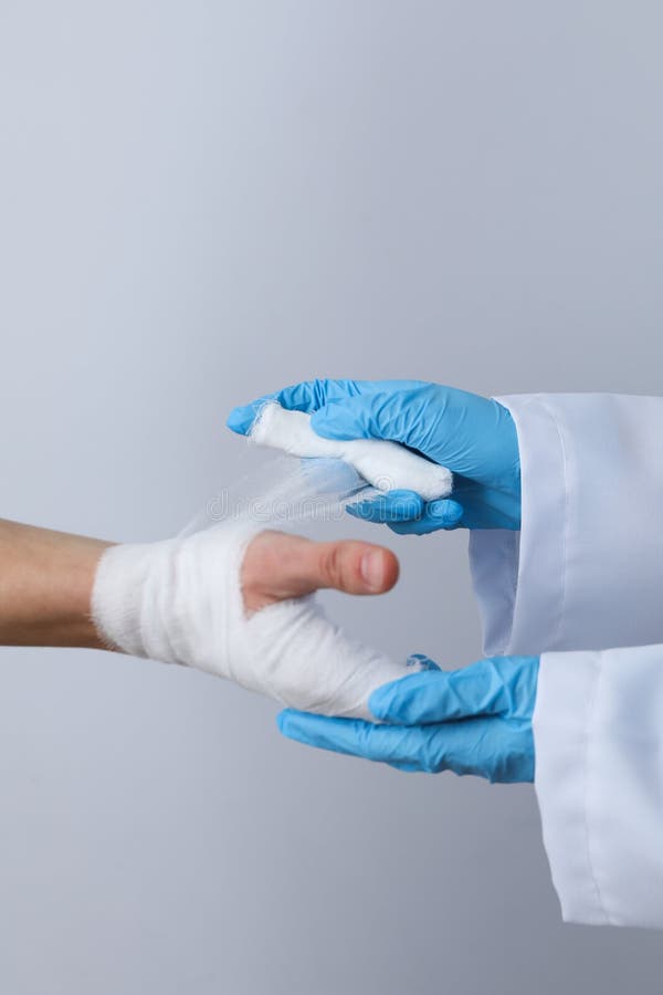 Concept of Help during an Injury, Doctor Wrapping Hand in Bandage on ...