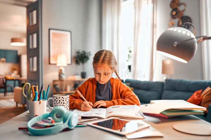 Concept of Homework. Concentrated Girl Using Workbook while Sitting by ...