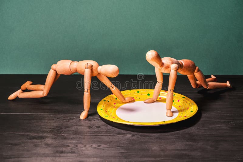 The Concept of Hunger and Poverty. People Look into an Empty Plate ...