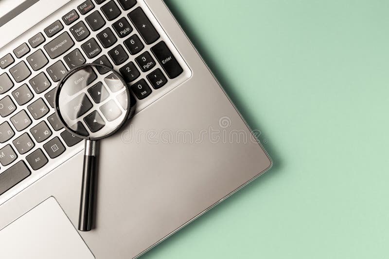 Concept Information Search. Laptop Computer with Magnifying Glass on ...