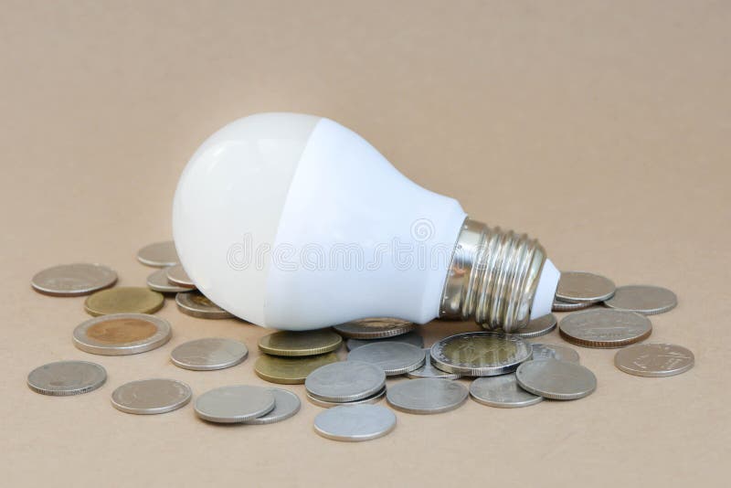 Concept of LED Bulb with Coins for Choice of Saving Technology Stock ...