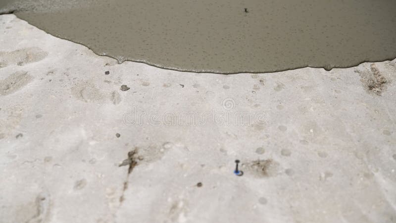 The Concept of Leveling the Floor Using a Mixture. Workers Pour ...