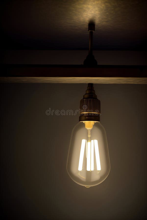 A Light Bulb Hanging from a Ceiling in a Dark Room. Generative AI Stock ...