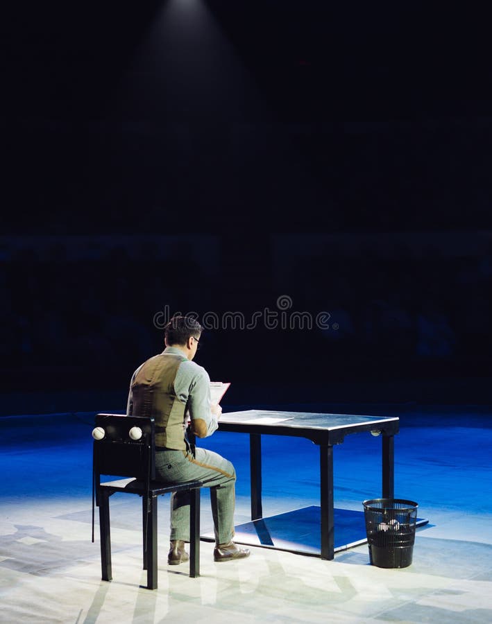 Concept. A Lone Office Worker Sits In A Dark Room. Stock Photo - Image ...