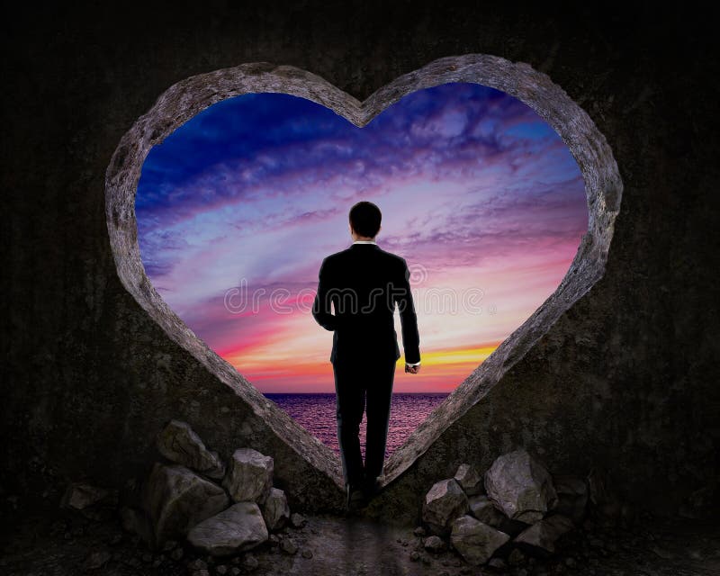 A Concept of Man Walking through the Hole in Wall in a Shape of Heart ...