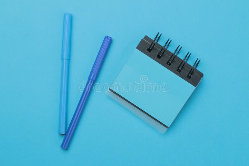 The Concept of Minimalism. Blue Notebook and Felt-tip Pens on a Bright ...