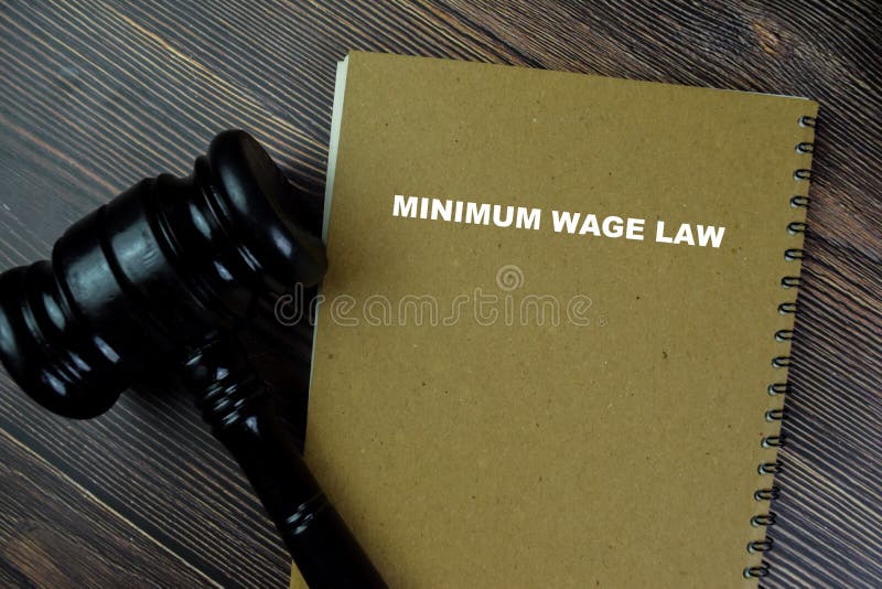 Concept of Minimum Wage Law Write on a Book with Gavel Isolated on Wooden Table Stock Image ...