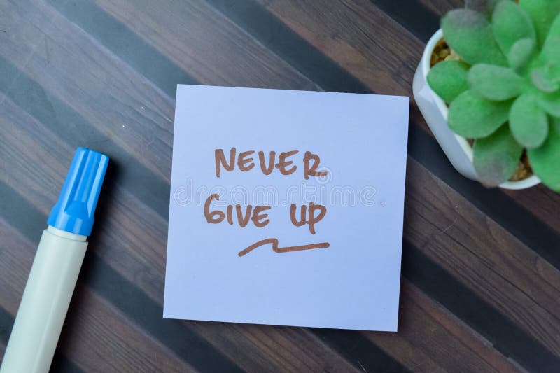Concept of Never Give Up Write on Sticky Notes Isolated on Wooden Table ...
