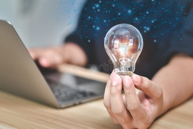 Concept of New Ideas and Innovation. Hands Holding Light Bulb for ...