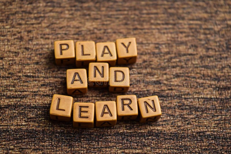 Concept of Play and Learn Message Written on Wooden Blocks. Stock Image ...